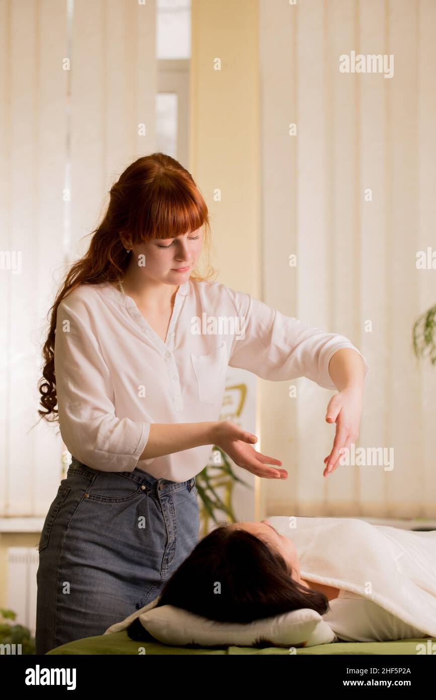 Reiki healer with etheric fingers cleans the patient's ether Stock ...