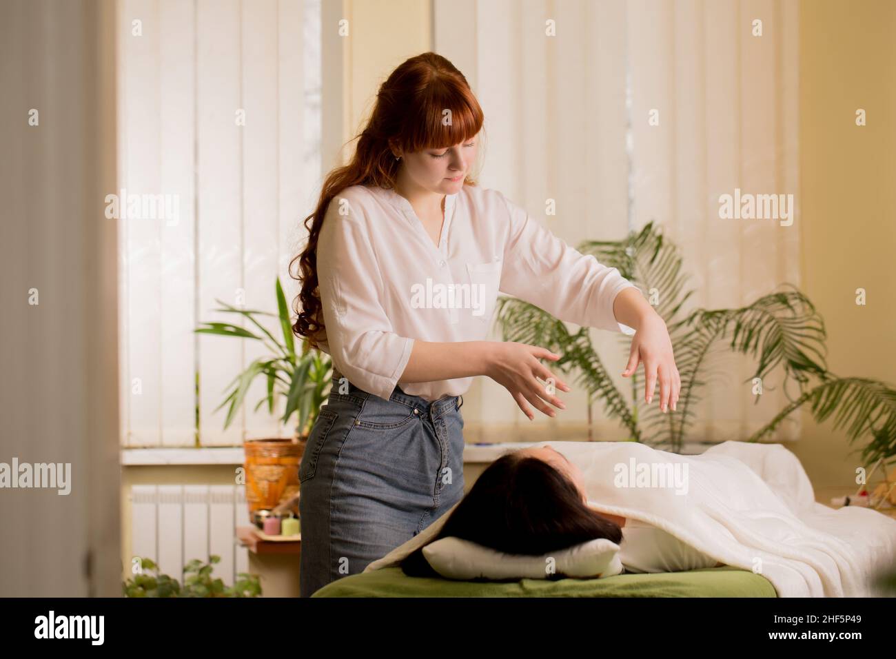 Reiki healer with etheric fingers cleans the patient's ether Stock ...