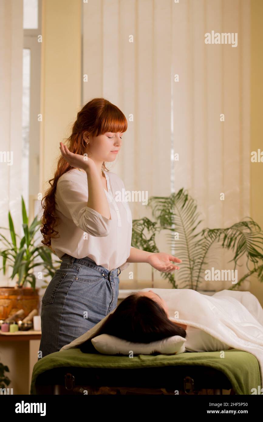 Reiki healer fills the patient's ether, energy healing Stock Photo - Alamy