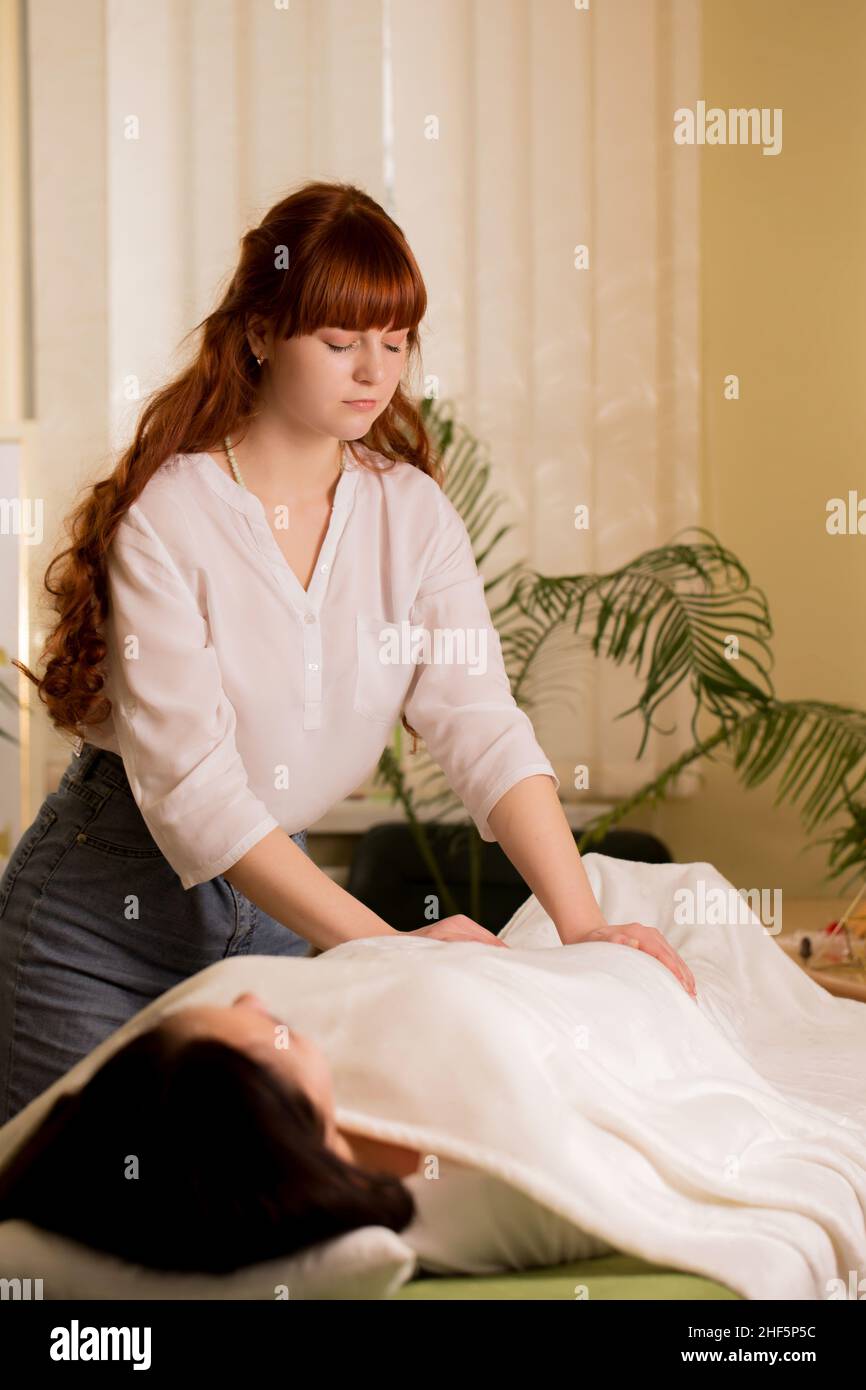 Reiki Healer makes cleaning and energizing the patient's legs Stock ...