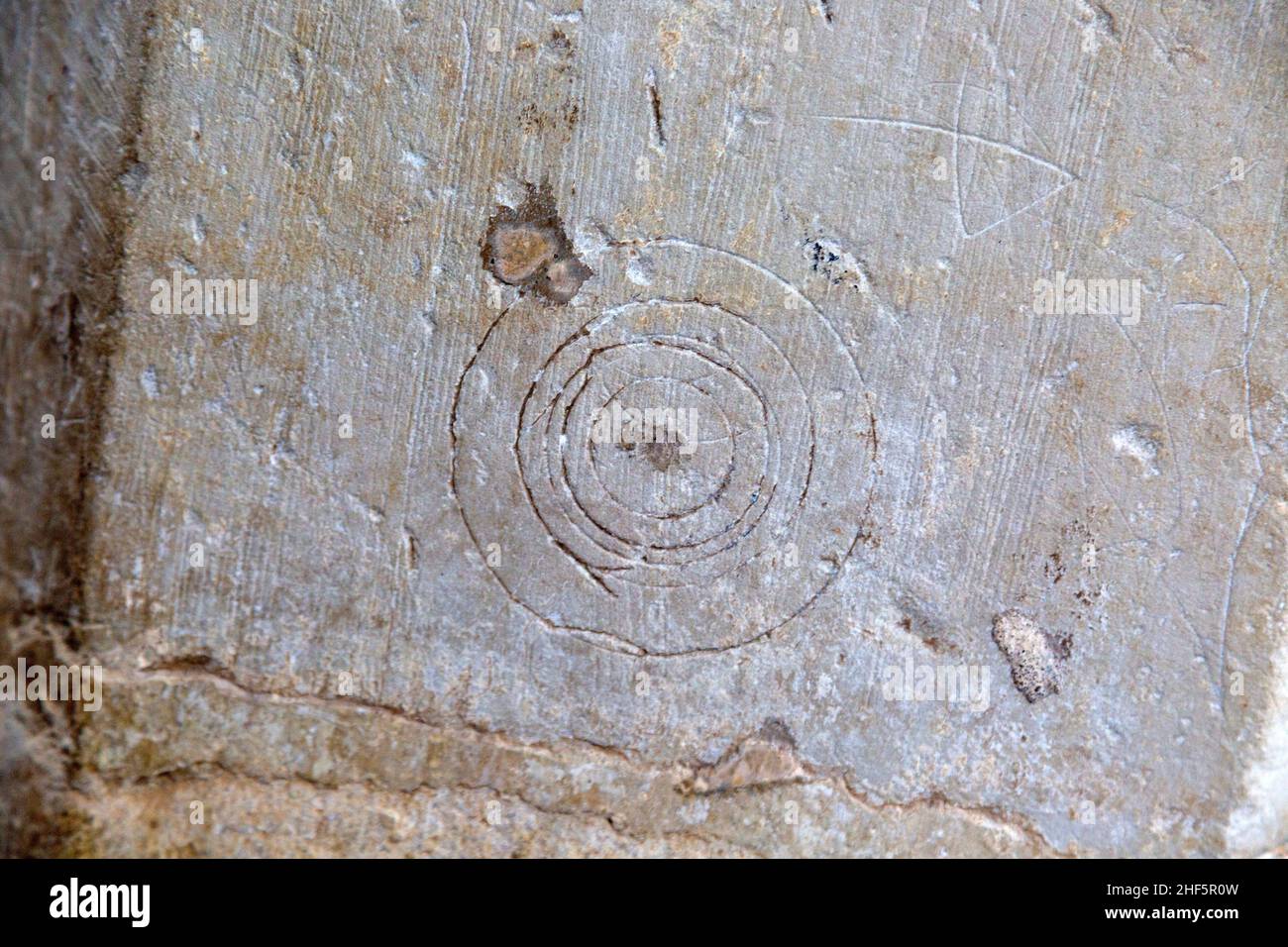 Inscription circular marks scratched on stone wall geometric shapes ...