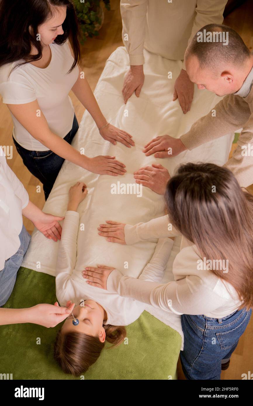 Group reiki healing session for the patient, top view Stock Photo - Alamy