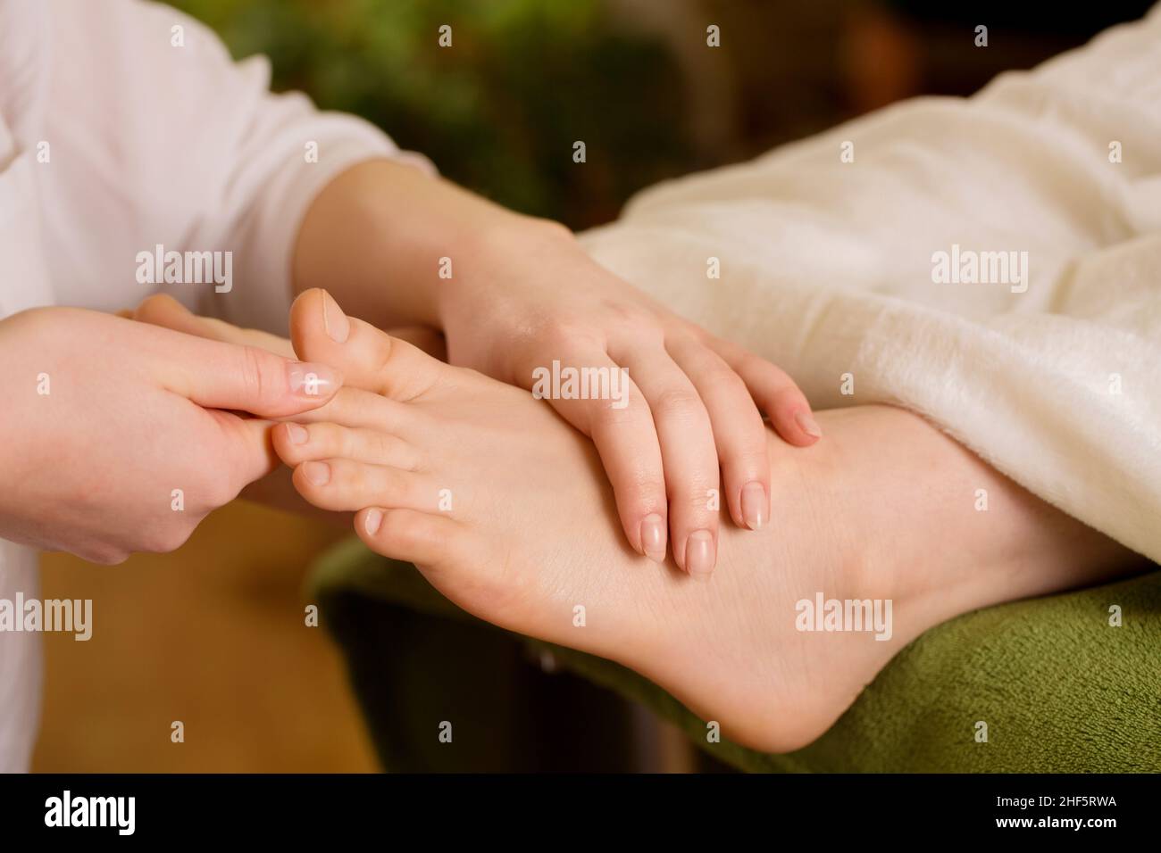 Energy cleansing feet in a stream of reiki. Foot massage Stock Photo ...