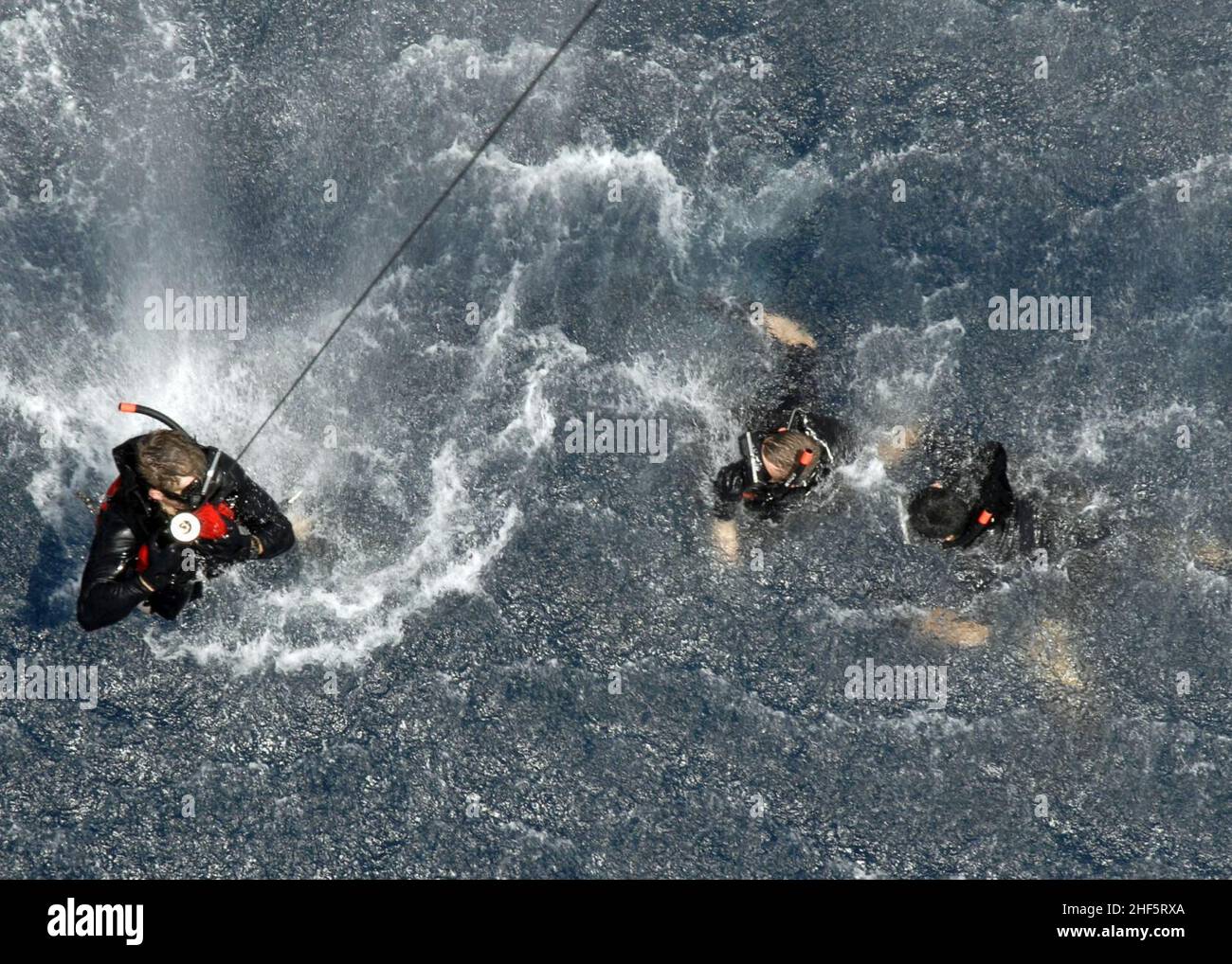 Search and rescue swimmers assigned to the amphibious assault ship USS ...
