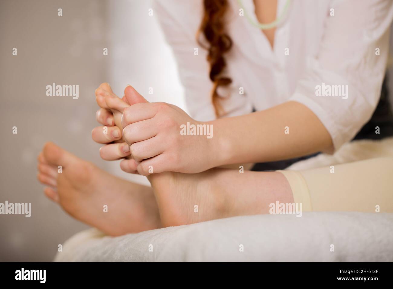 Energy cleansing feet in a stream of reiki. Foot massage Stock Photo ...