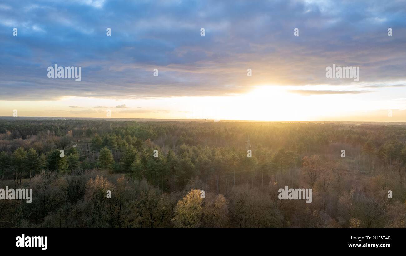 Beautiful sunset over a river with green bushes and color rich sky ...