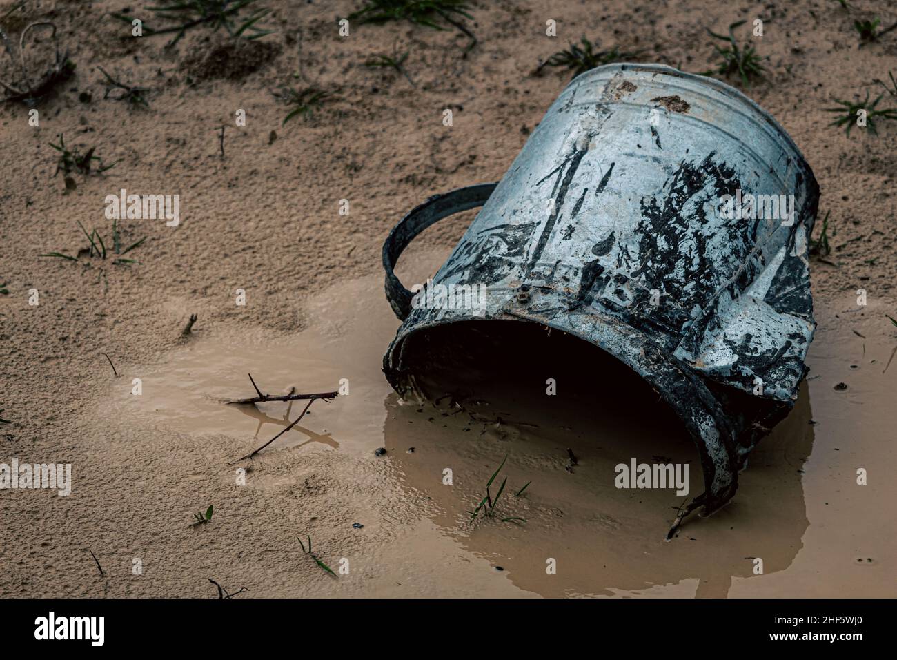 Old bucket left in the mud Stock Photo - Alamy