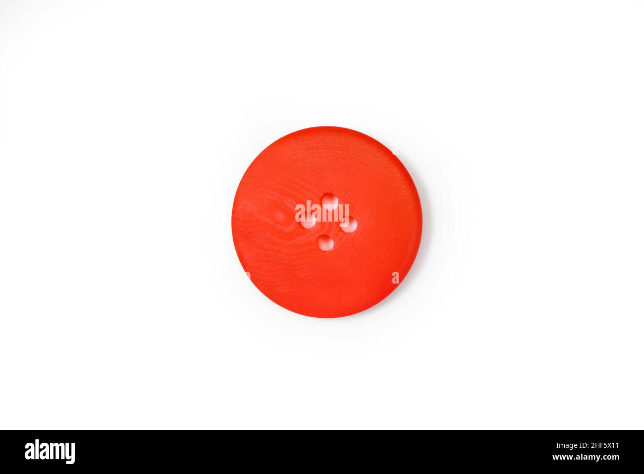 A red button isolated on a white background in a close up view Stock ...