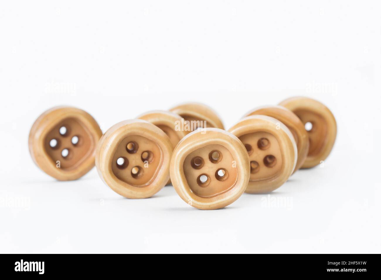 Standing brown buttons isolated on a white background with copy space ...