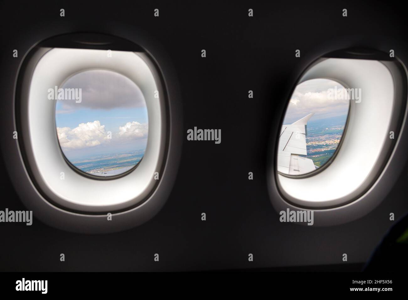 aerial out of an aircraft window with clouds and landscape Stock Photo ...