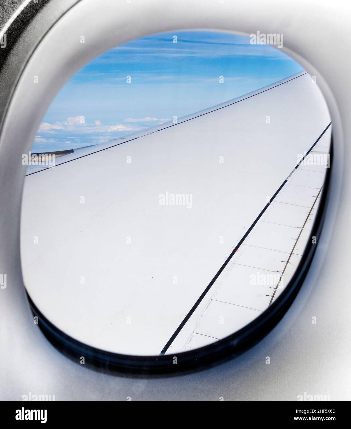 aerial out of an aircraft window with clouds and landscape Stock Photo ...