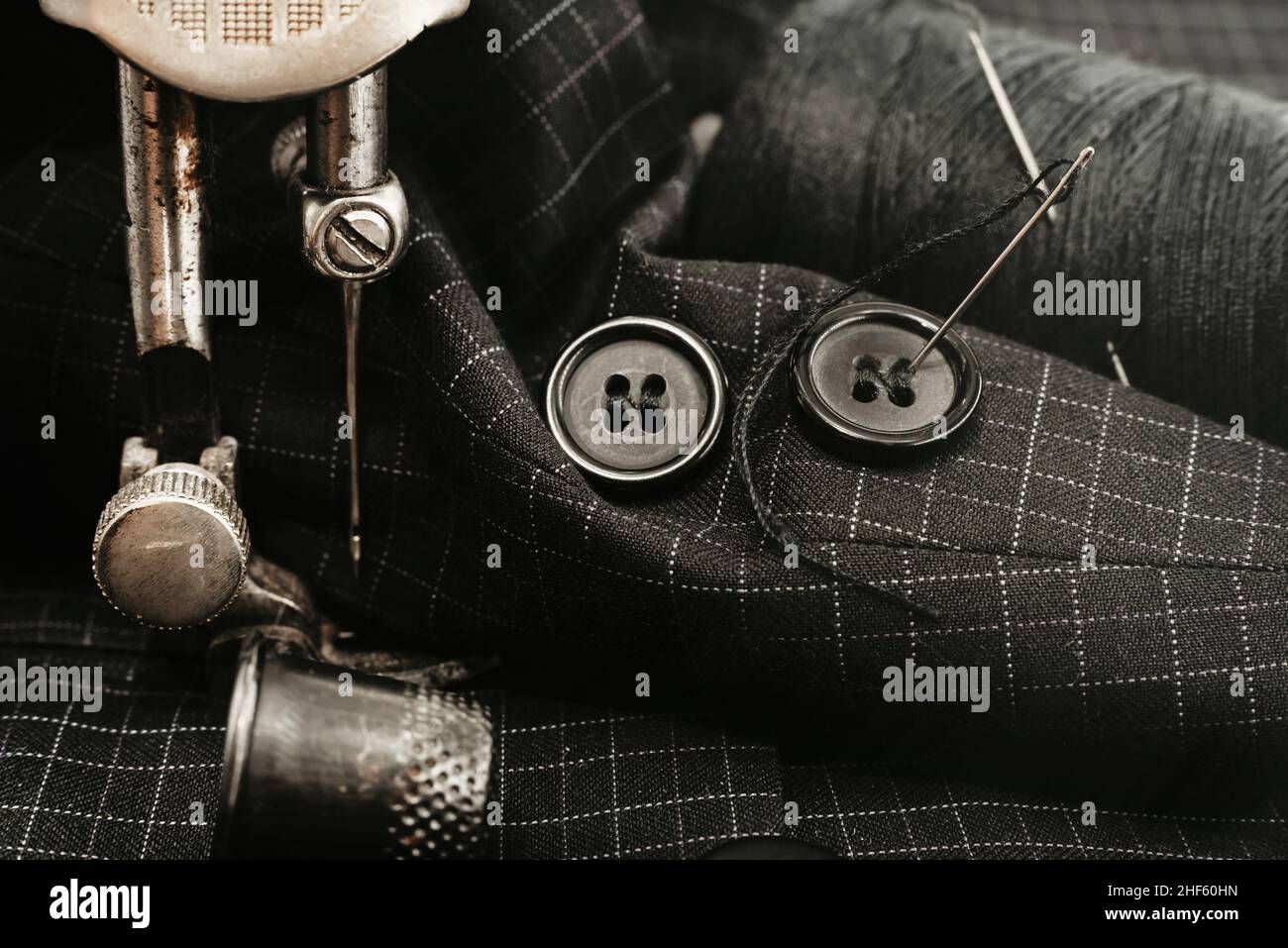 Old retro sewing machine, needle with thread, scissors and thimble ...