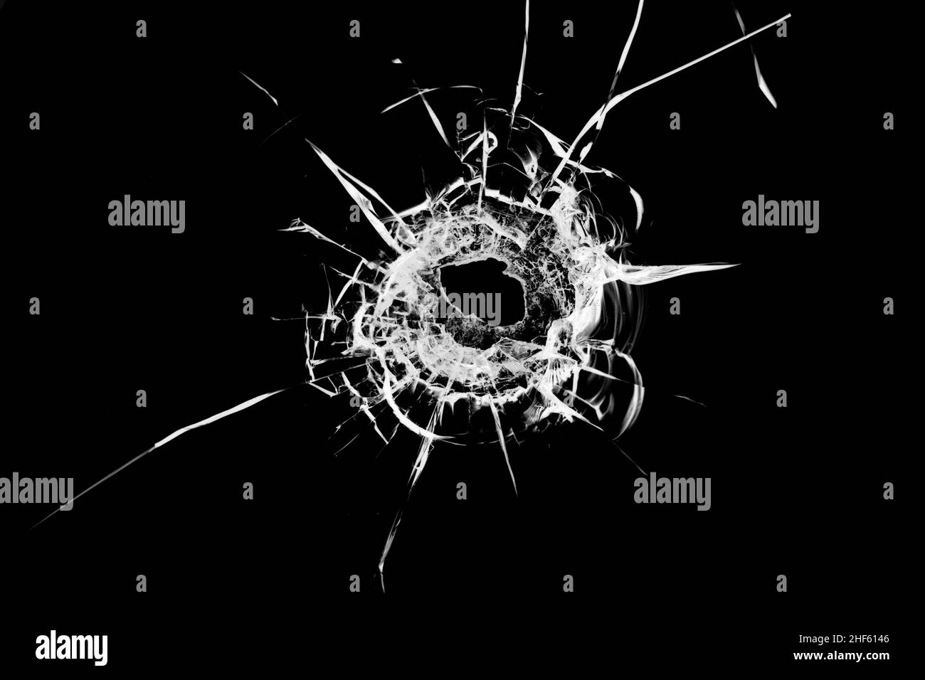 Texture of broken glass. Hole from a ball on a black background Stock ...