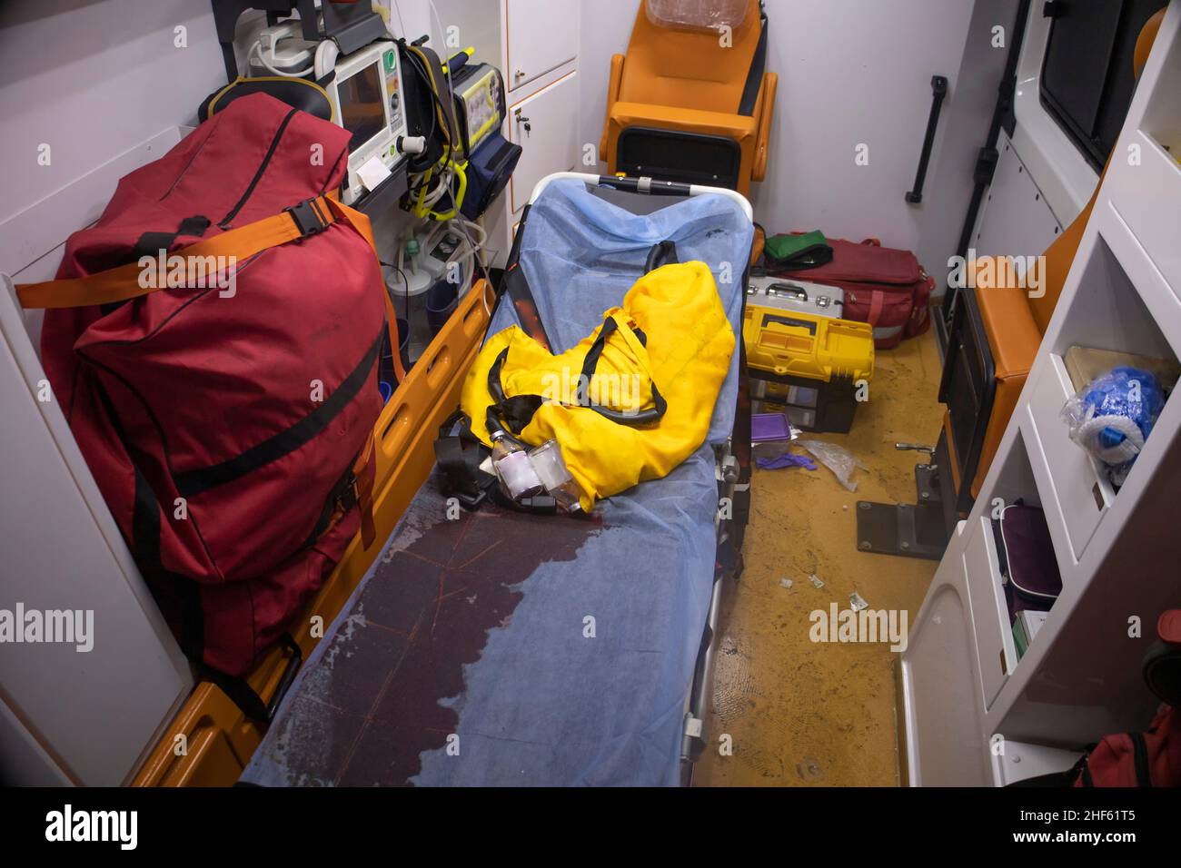 Ambulance after the patient. Dirty burdens with blood and scattered ...