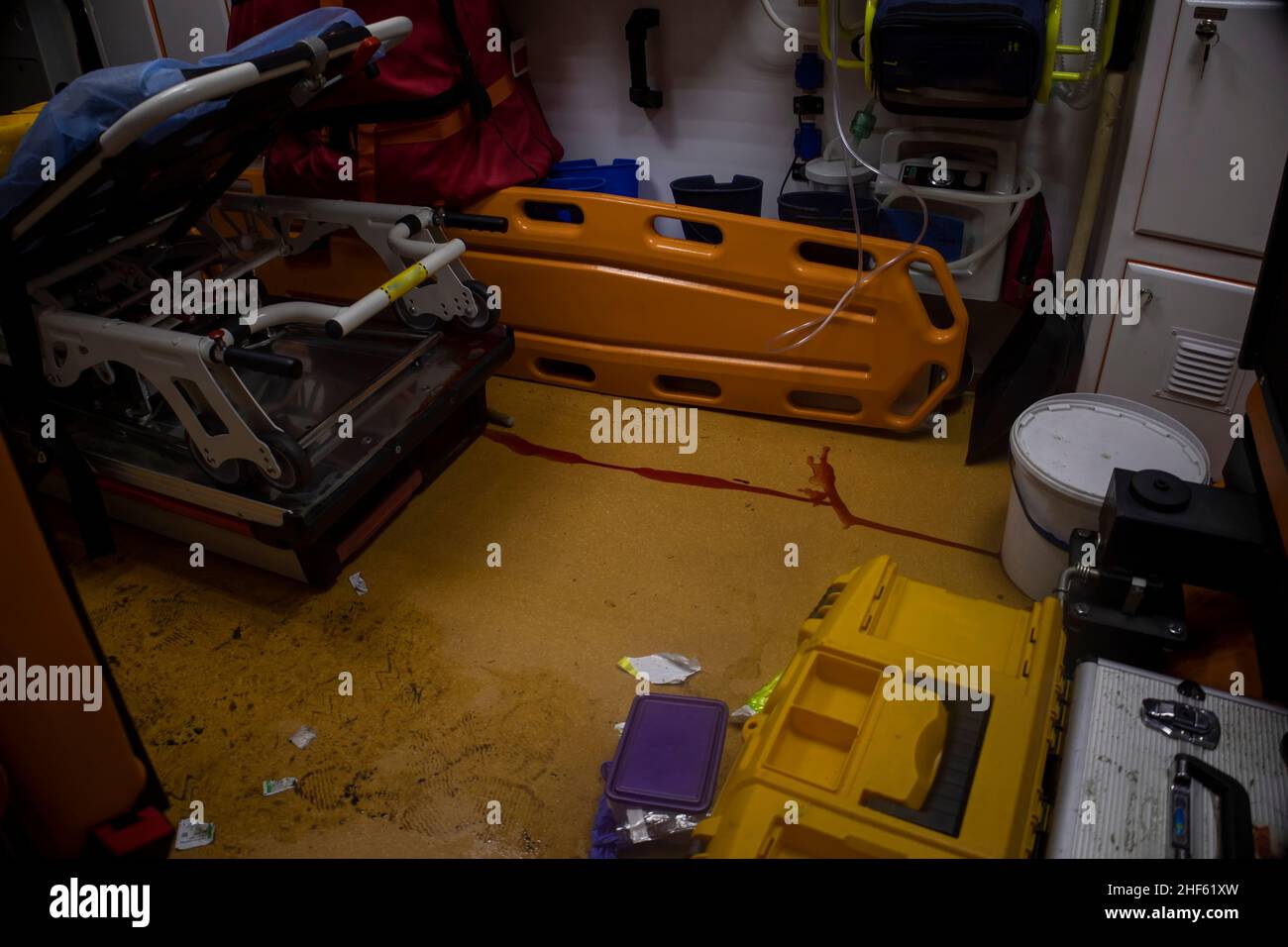 Ambulance after the patient. Dirty burdens with blood and scattered ...