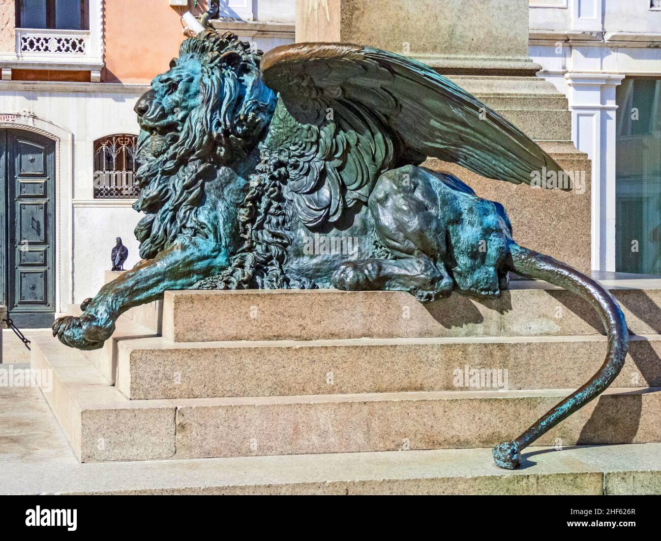 Ancient winged lion on the steps of the monument - Venice, Italy Stock ...