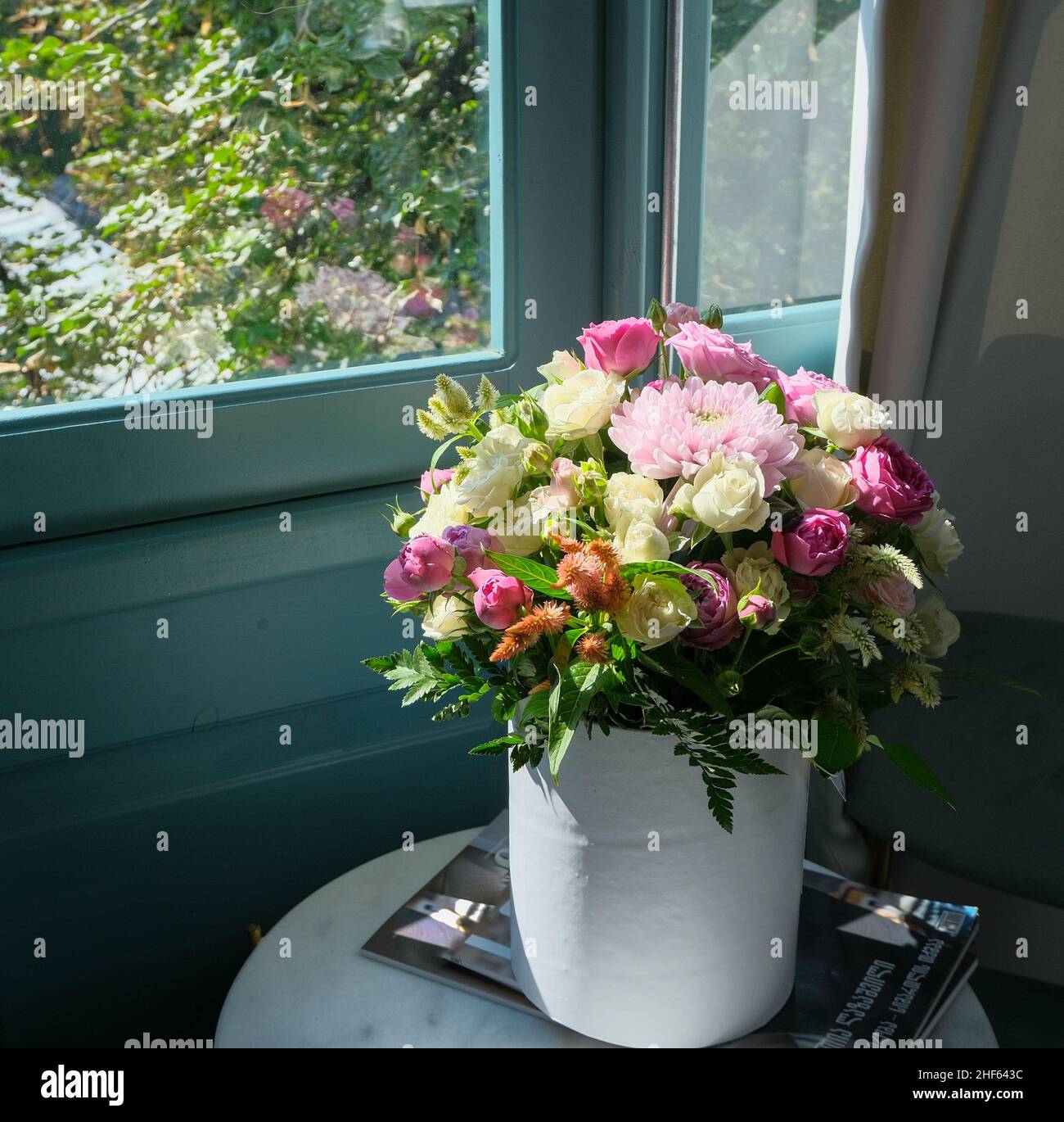 Beautiful bouquet of fresh flowers on the table near the window Stock ...