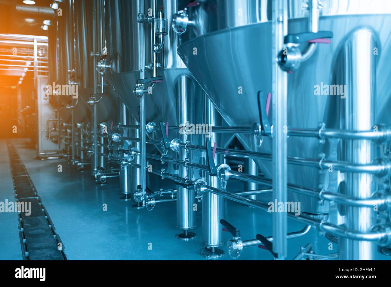 Industrial interior of modern craft brewery with chrome cylindrical ...