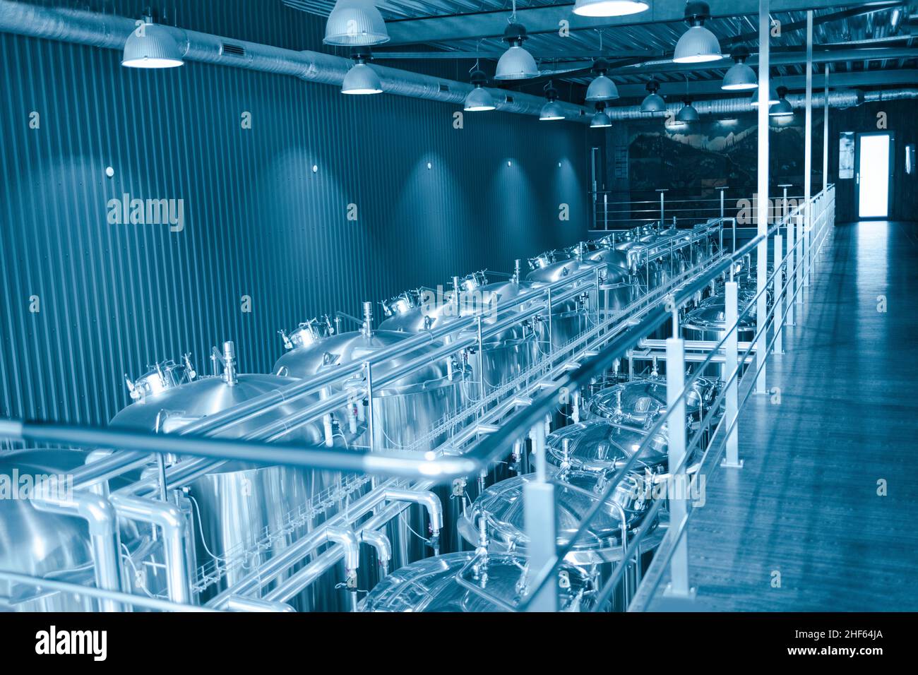 Private microbrewery. Modern beer plant with brewering kettles, tubes ...