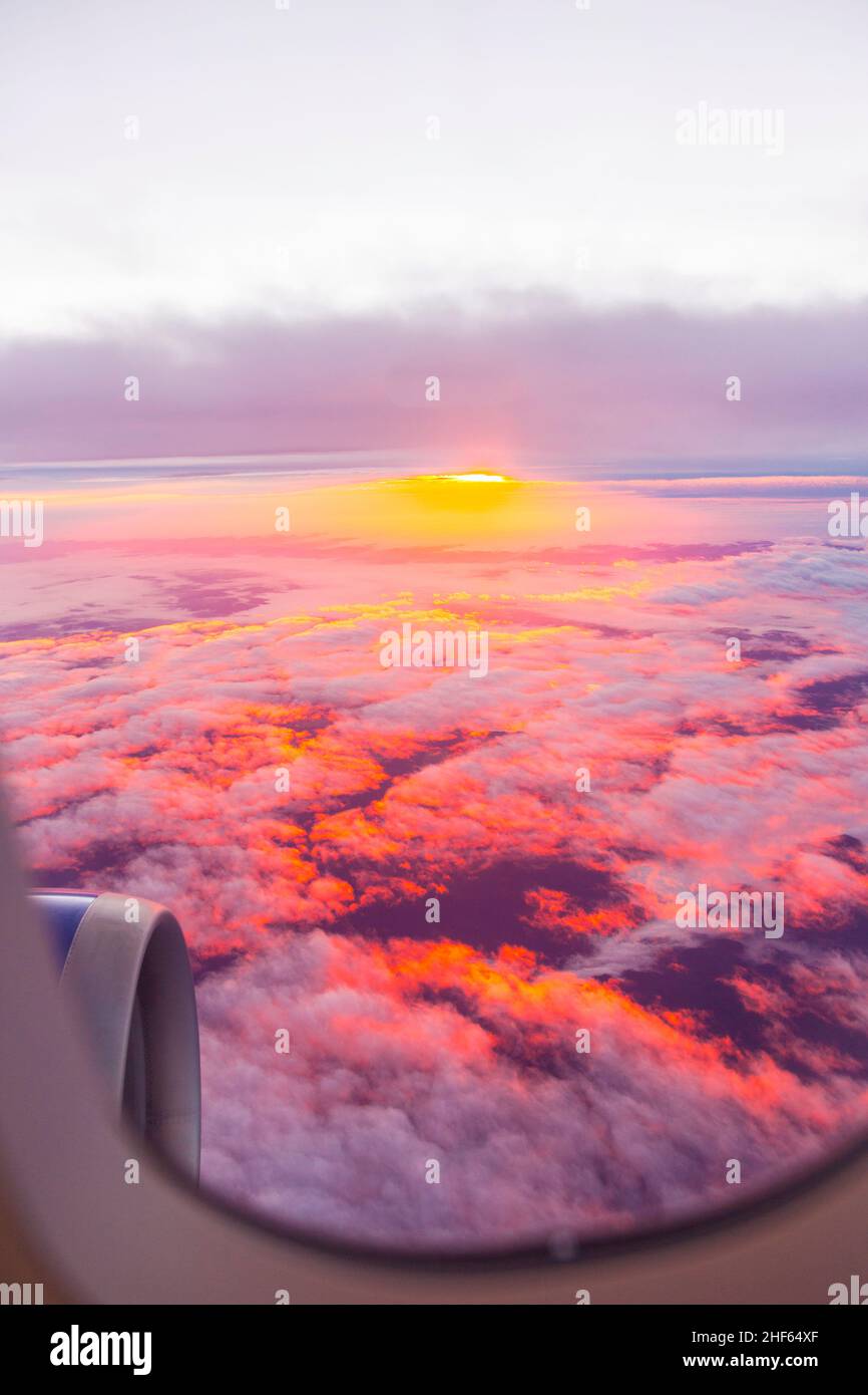spectacular sunrise over the clouds seen from aircraft Stock Photo - Alamy
