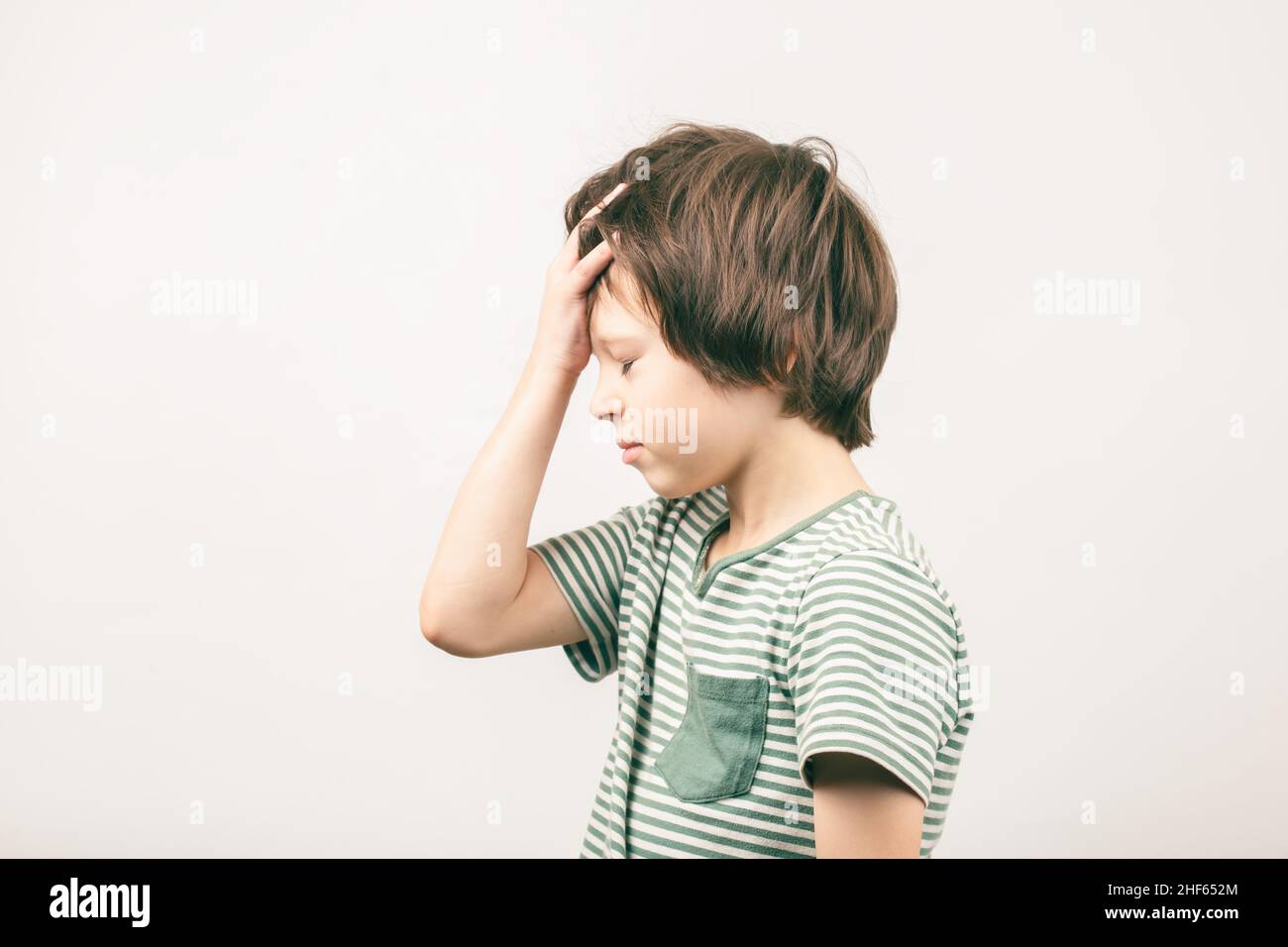 Disappointed little school age boy placing hand on head. Face palm ...
