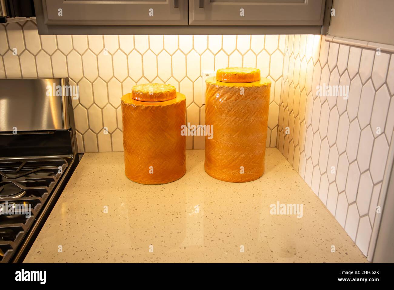 Two Ceramic Containers With Lids On Kitchen Counter Top With Back ...