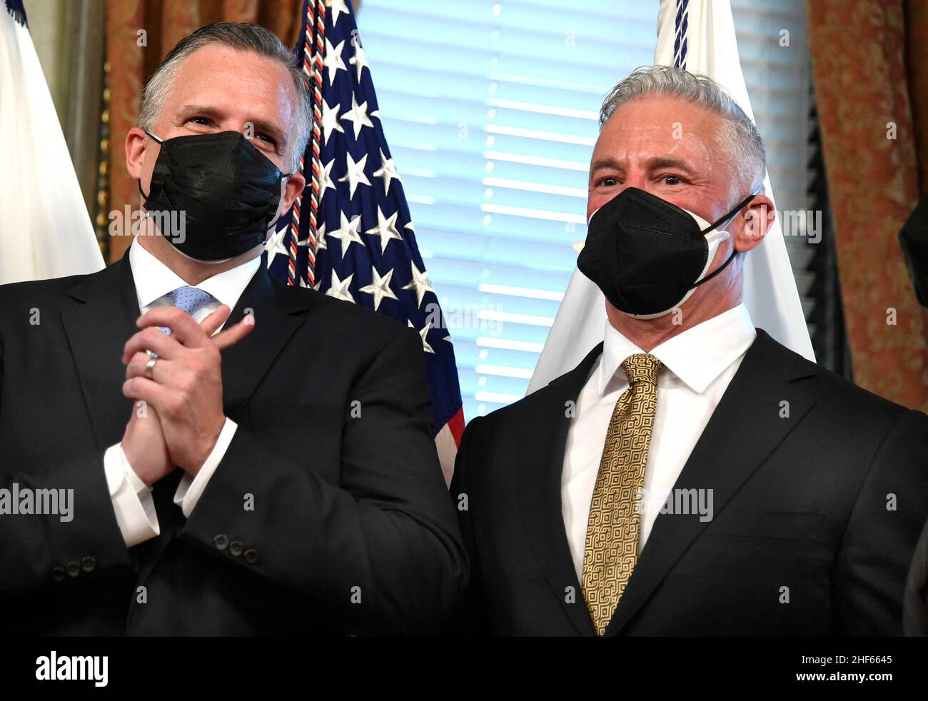 The State Department's Chief of Protocol Rufus Gifford (L) clasps his ...