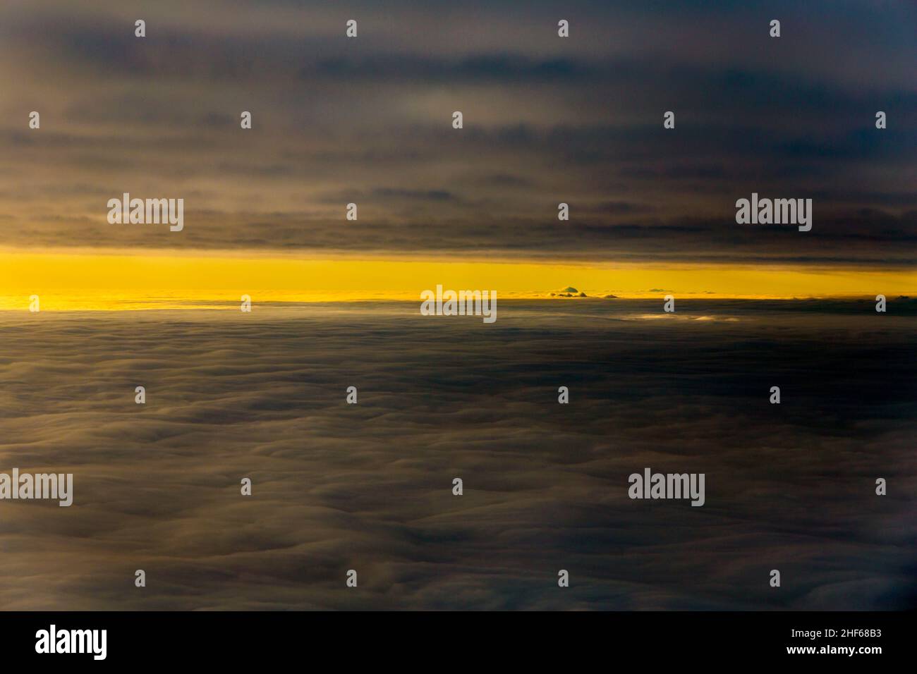 sunset between clouds with bright sun Stock Photo - Alamy