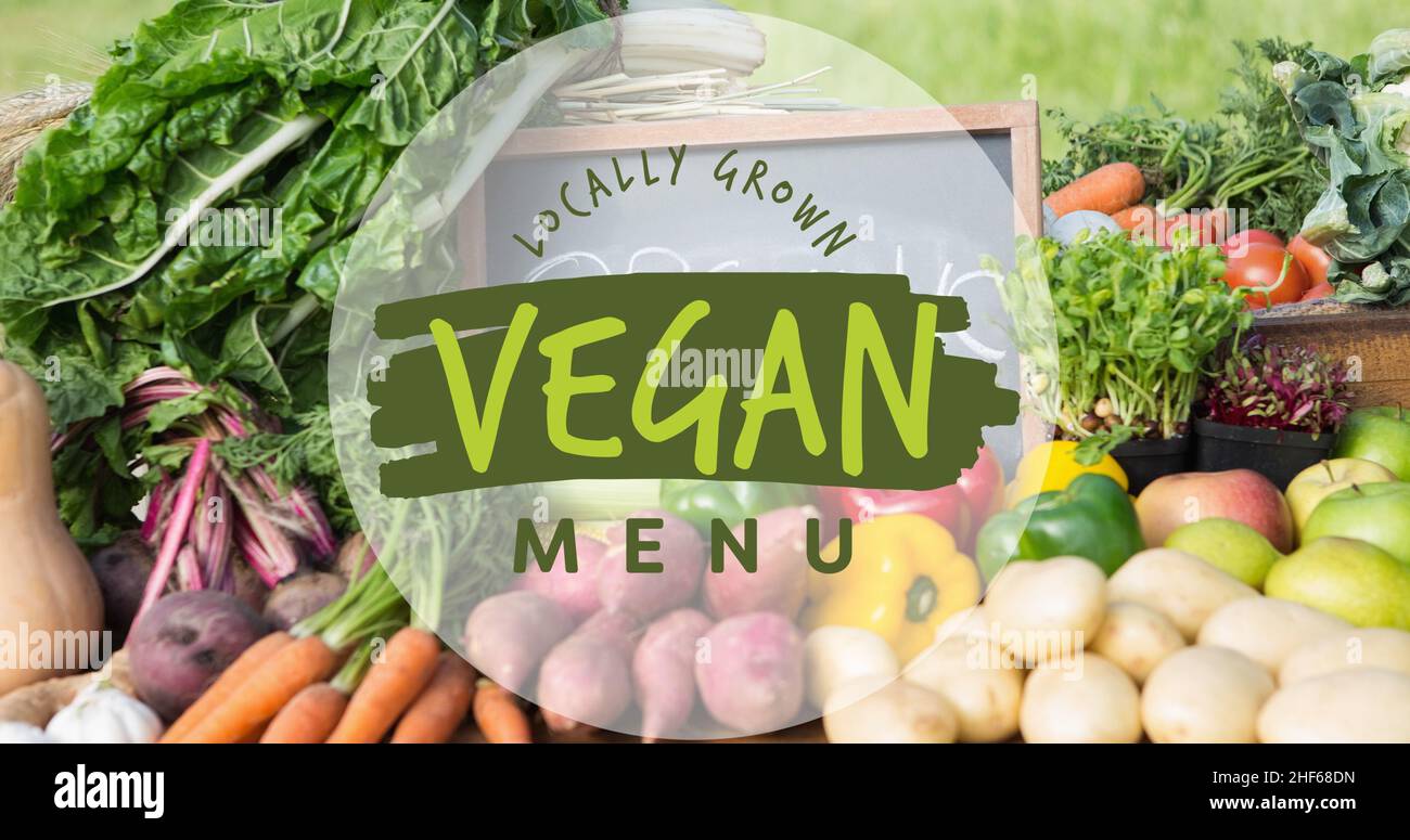 Close-up of locally grown vegan menu symbol over fresh vegetables Stock ...