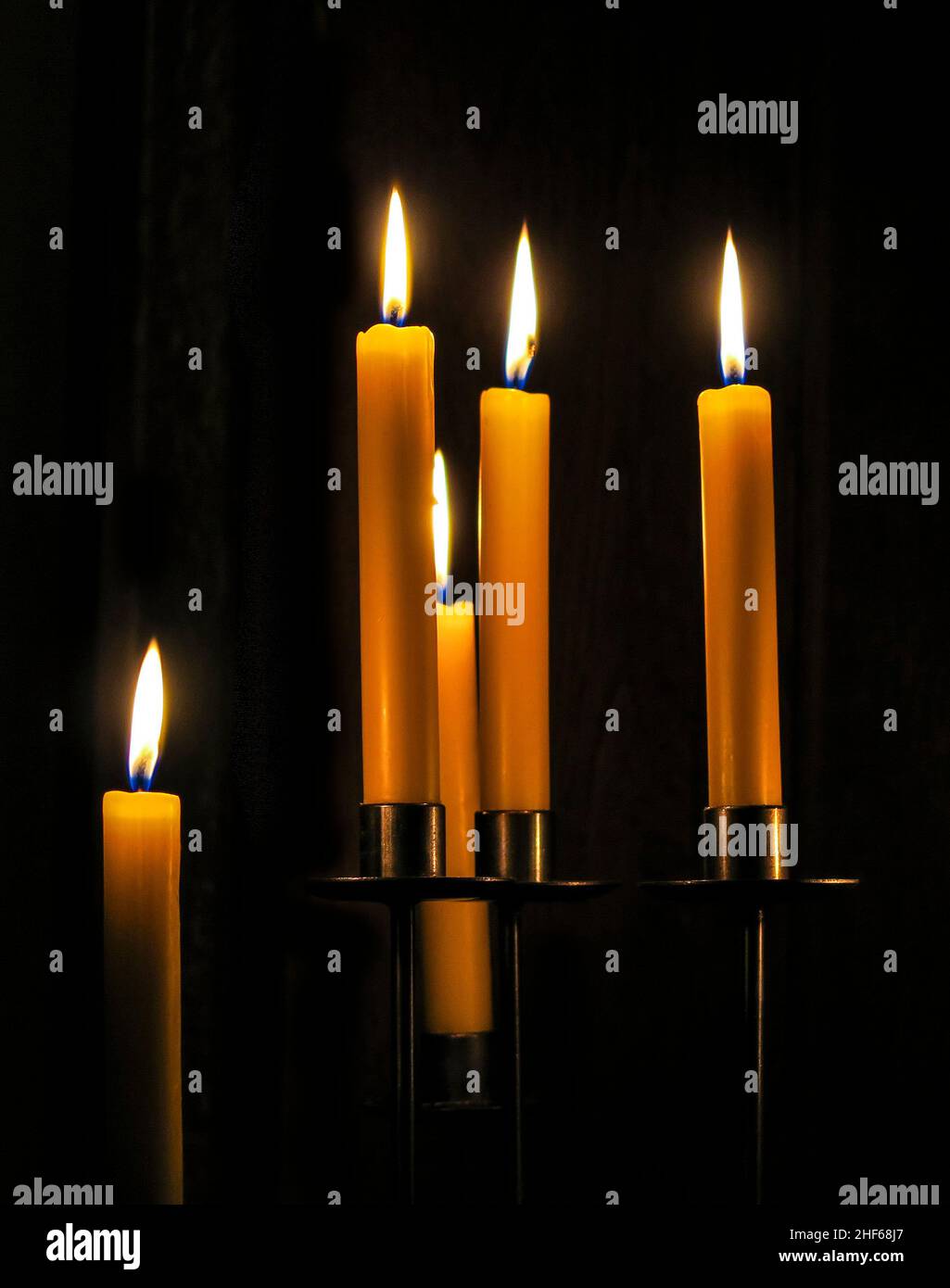 Candles burning in a dark room without other light Stock Photo - Alamy