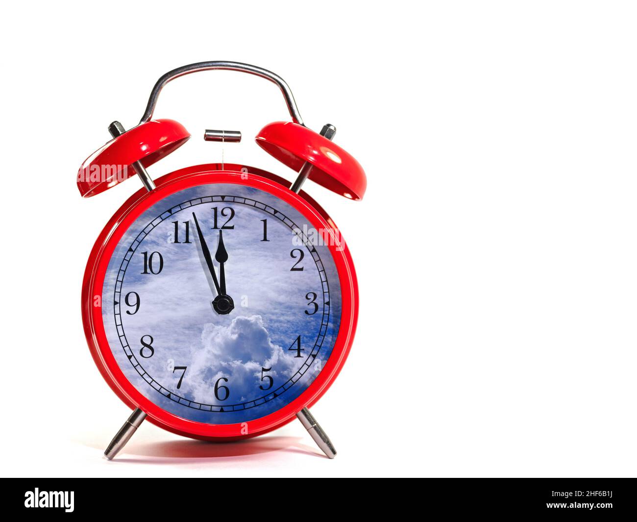 Red alarm clock with clouds on the clock face against a white ...