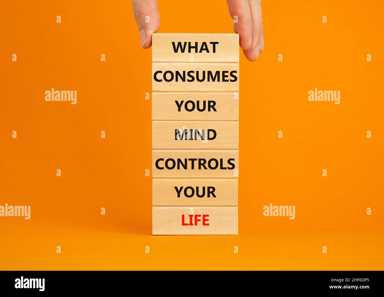 Motivational symbol. Wooden blocks with words What consumes your mind ...