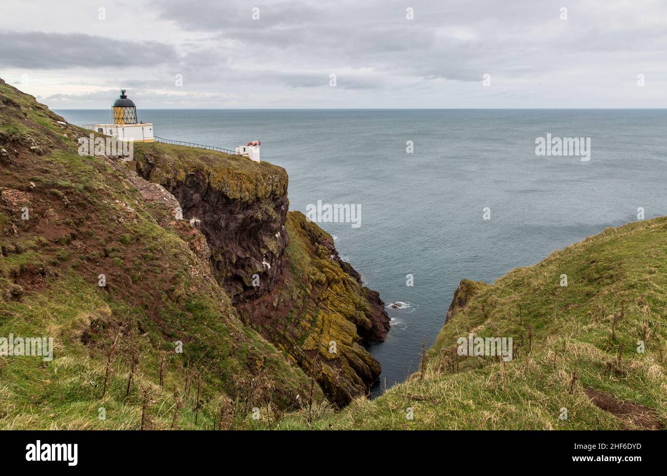 The Lighthouse and foghorn of St Abbs Head Lighthouse, perched on the cliff edge above the North ...
