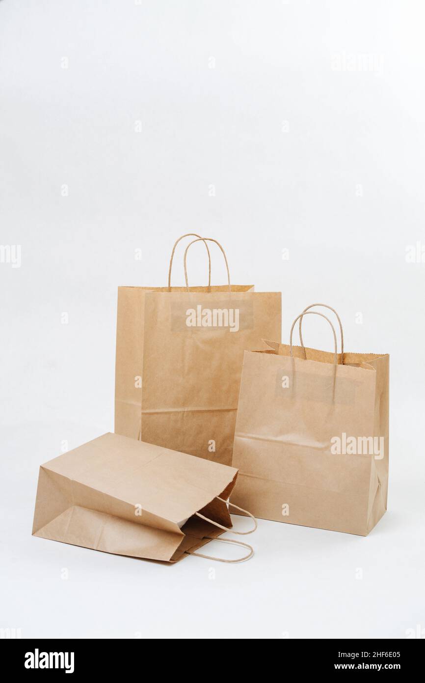 Composition of three empty brown paper bags over white background Stock ...