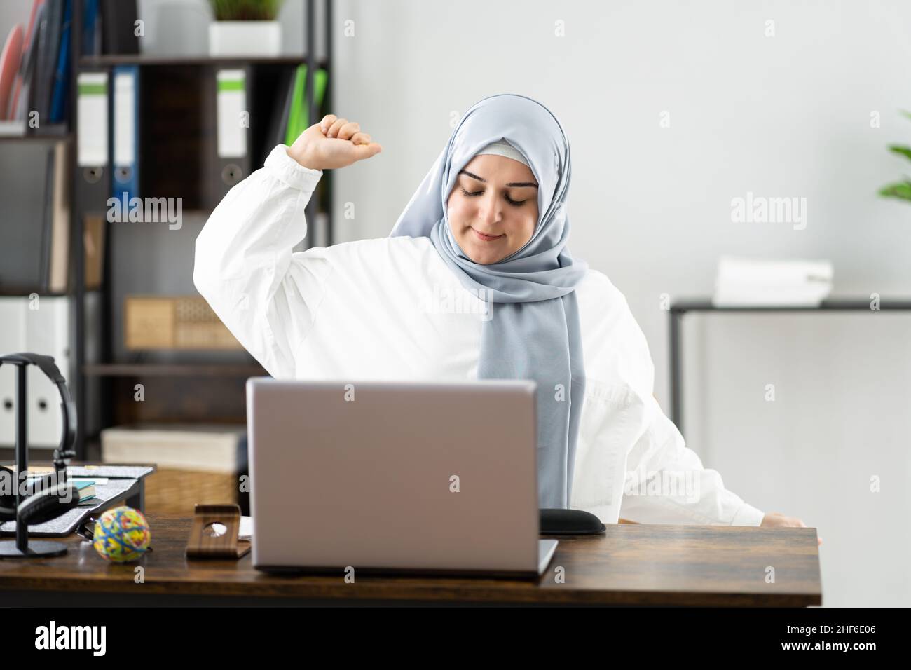 Stretch Exercise At Office Desk Near Computer Stock Photo - Alamy