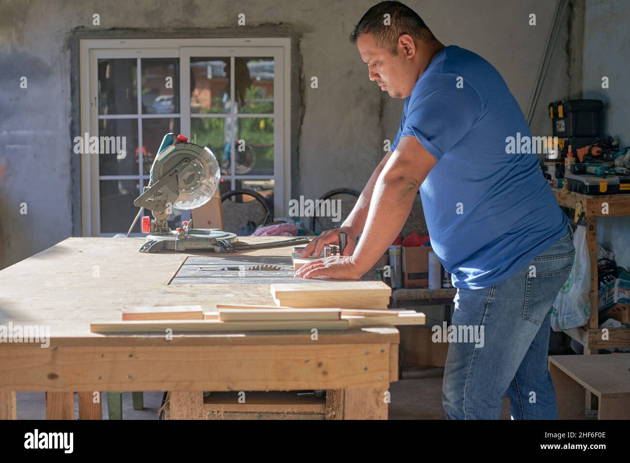 latin man working in a wood workshop Stock Photo - Alamy