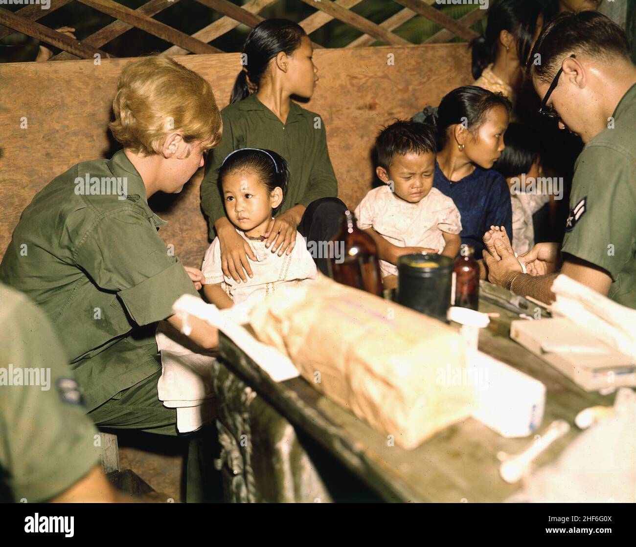 Second Lieutenant Kathleen M. Sullivan treats a Vietnamese child during Operation MED CAP, a U.S ...