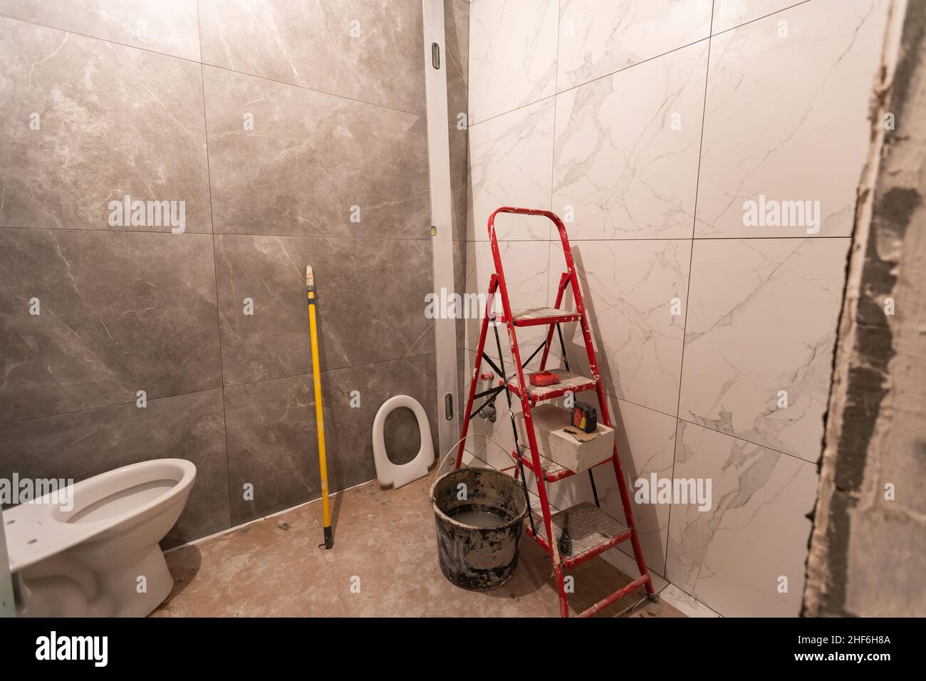 bathroom renovation and tiling. Laying floor ceramic tile Stock Photo ...