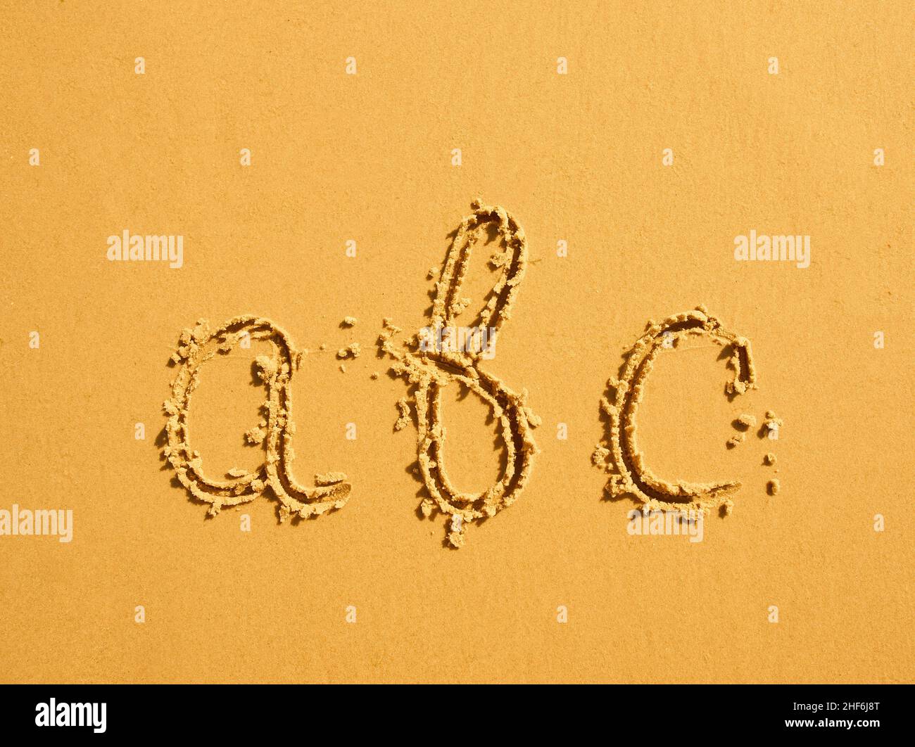 alphabet letters a b c handwritten in sand on beach Stock Photo - Alamy