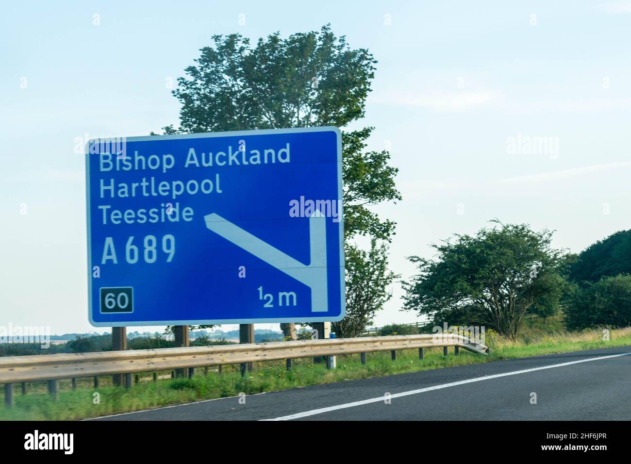 Blue road sign on a British, UK, motorway for junction 60 off the busy ...