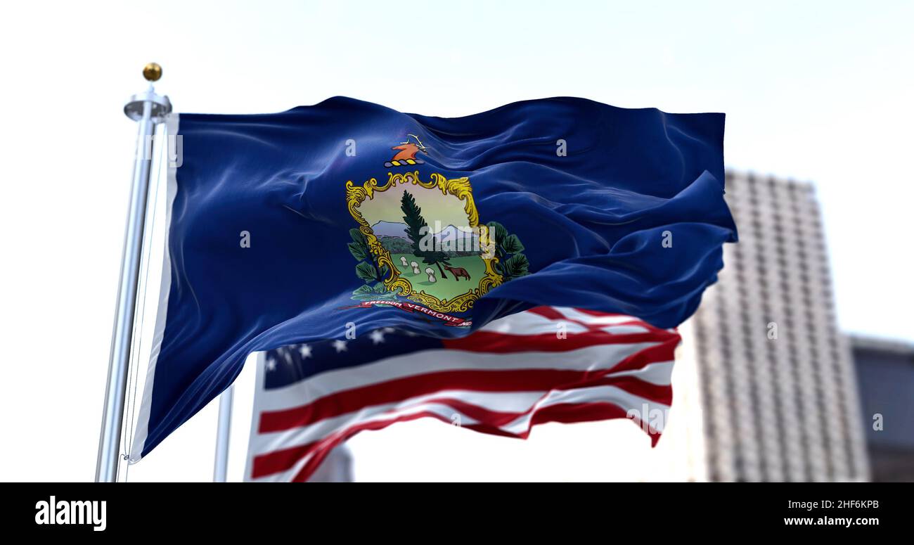 the flag of the US state of Vermont waving in the wind with the ...