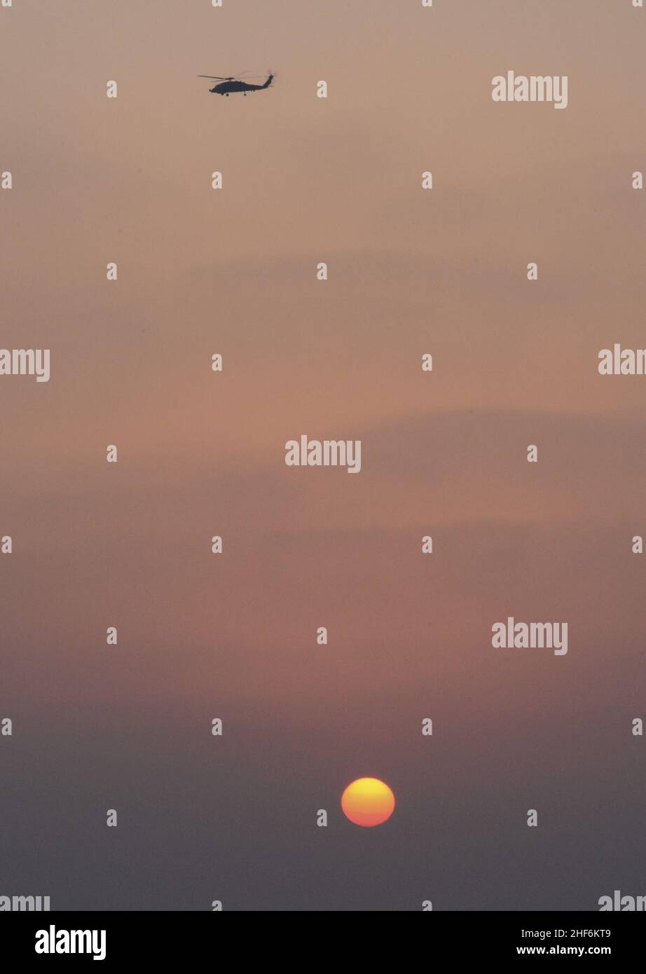 Seahawk patrols at sunset 141017 Stock Photo - Alamy