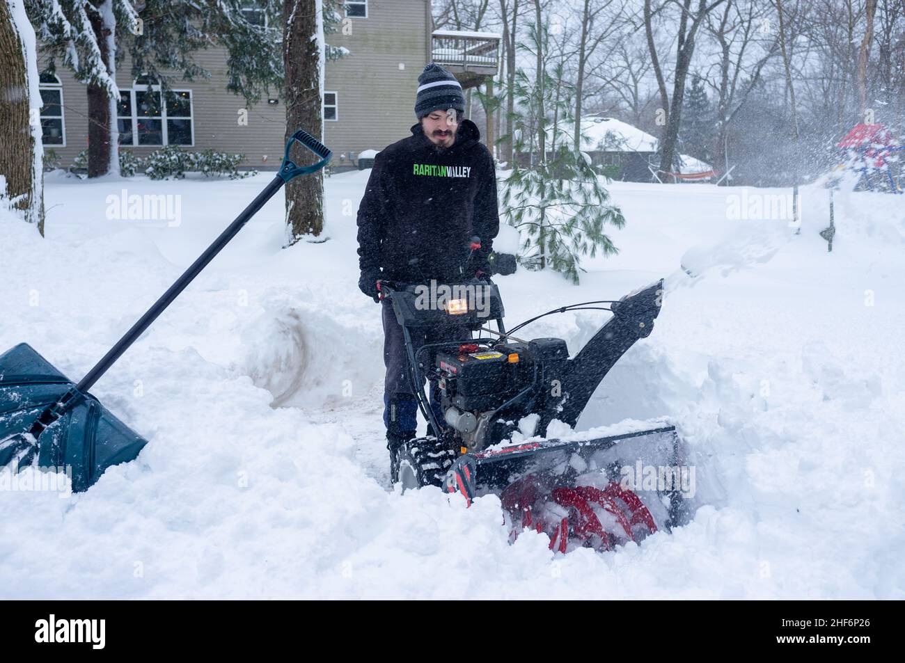 young man cleaning backyard with snow blower after the snow storm Stock ...