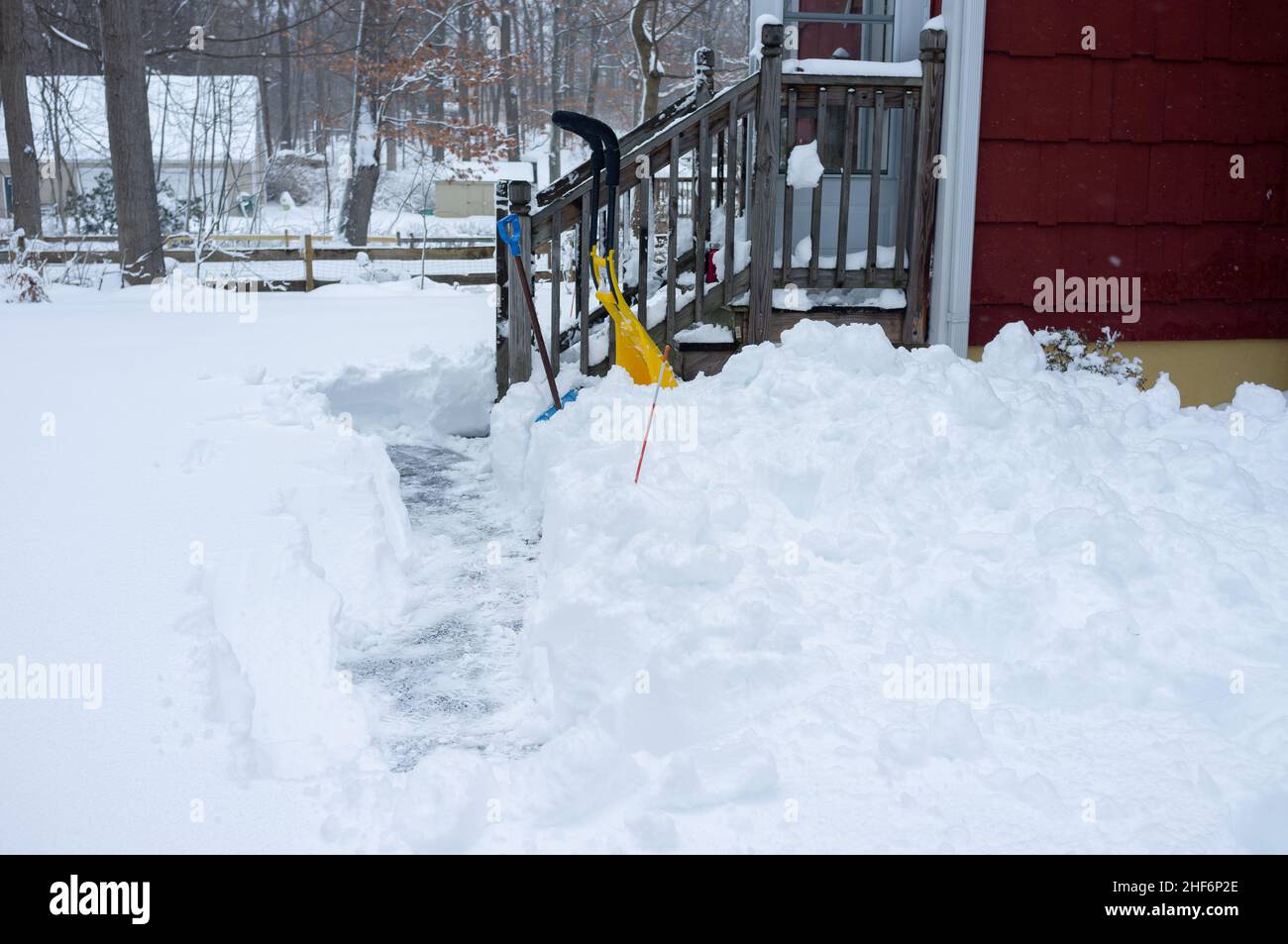 digging out a path in backyard covered with snow after a snow storm ...