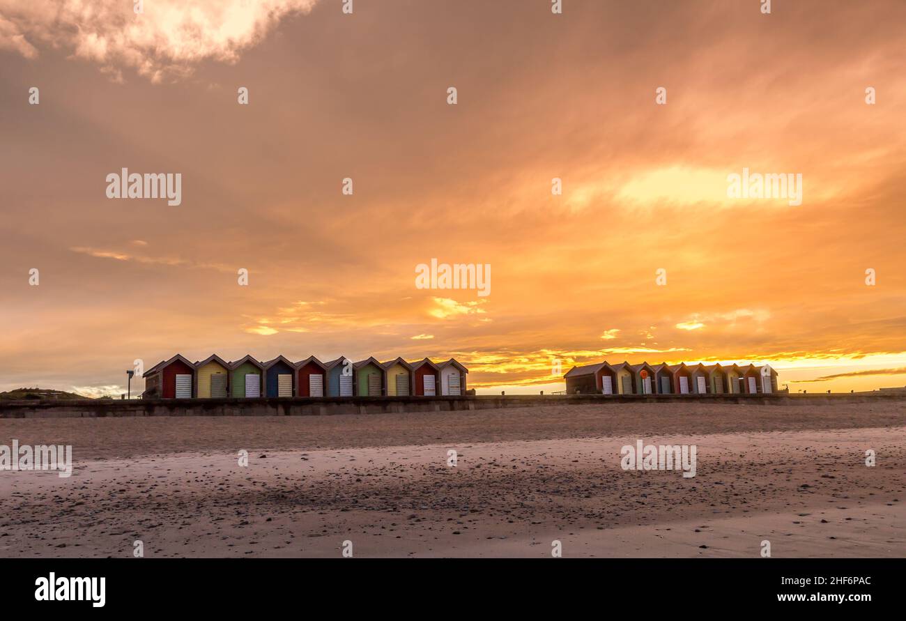 The vibrant and colorful beach huts by the promenade overlooking Blyth ...
