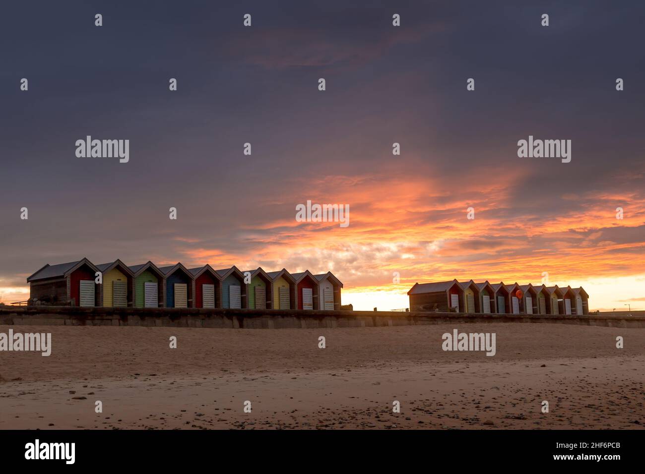 The vibrant and colorful beach huts by the promenade overlooking Blyth ...