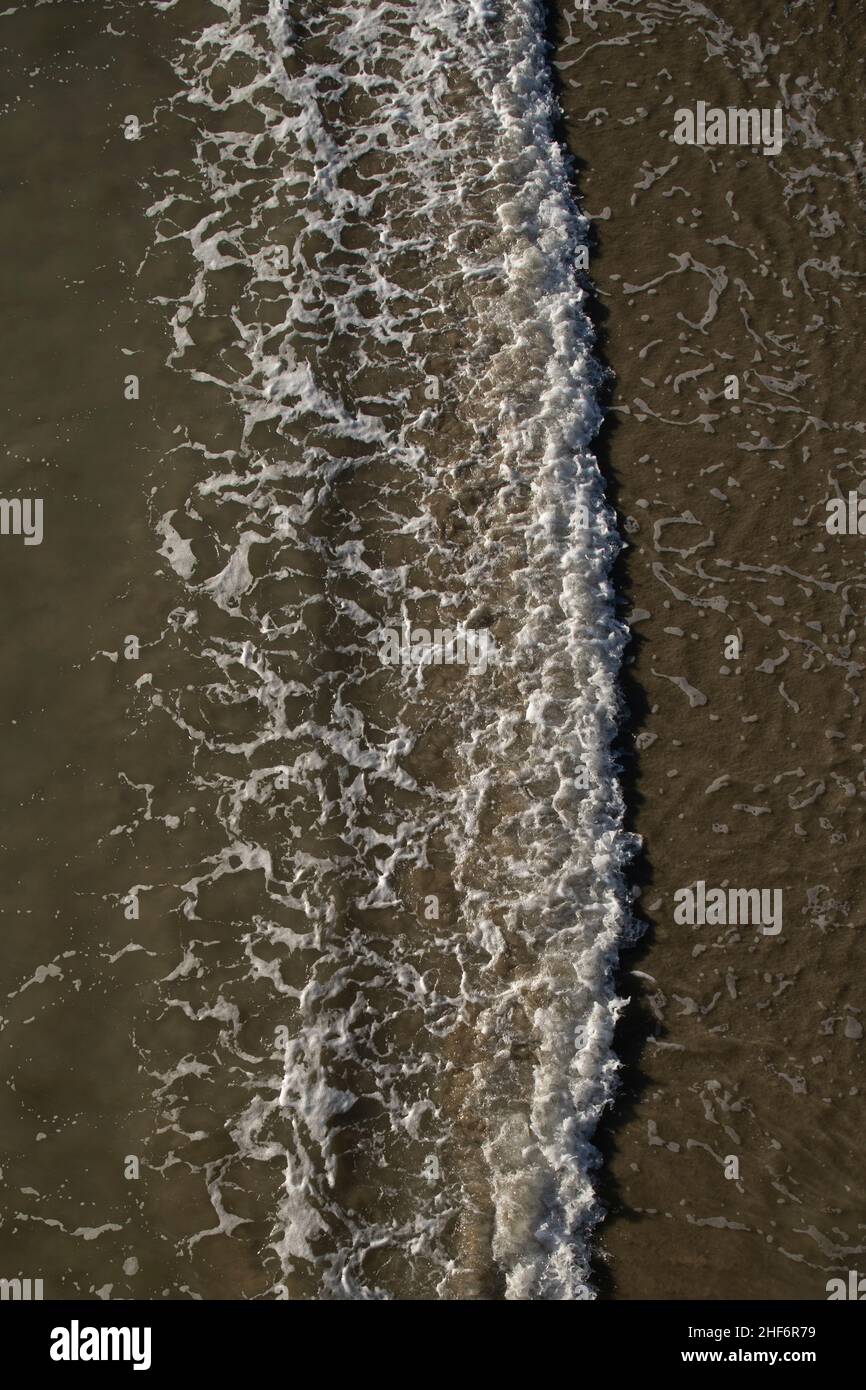 Ariel View Of Waves Against Sand On A Beach Stock Photo - Alamy