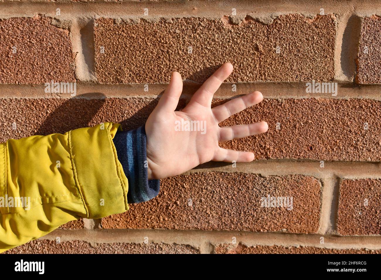 close up of little boys hand and arm, with his fingers spread out ...