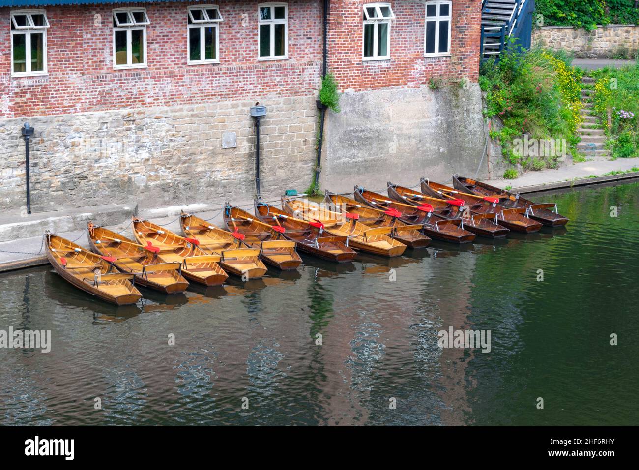 Rowing boats lined up on the Wear river in the city centre of Durham ...