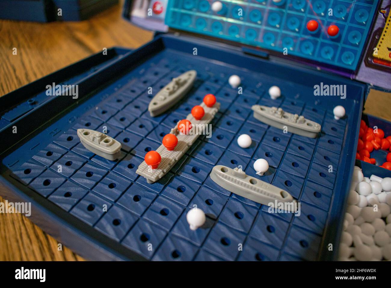 Plastic toy warships and submarines are placed on the playing board ...